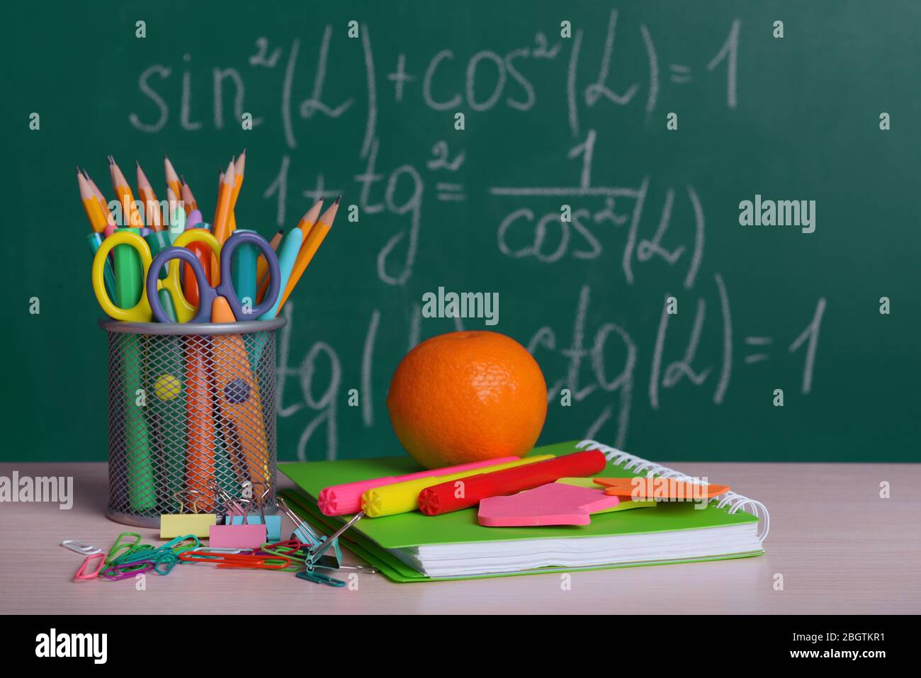 School supplies on table on board background Stock Photo - Alamy