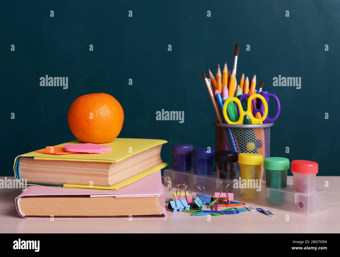 School supplies on table on board background Stock Photo - Alamy