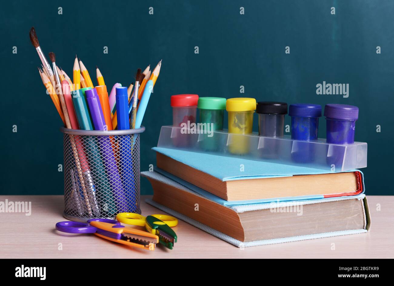 School supplies on table on board background Stock Photo - Alamy