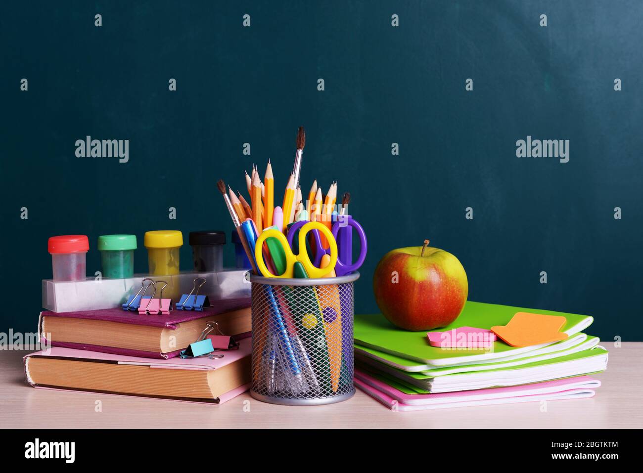 School supplies on table on board background Stock Photo - Alamy