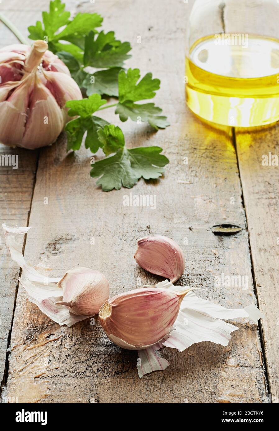 Still life of cooking condiments. Garlic, parsley and olive oil ...
