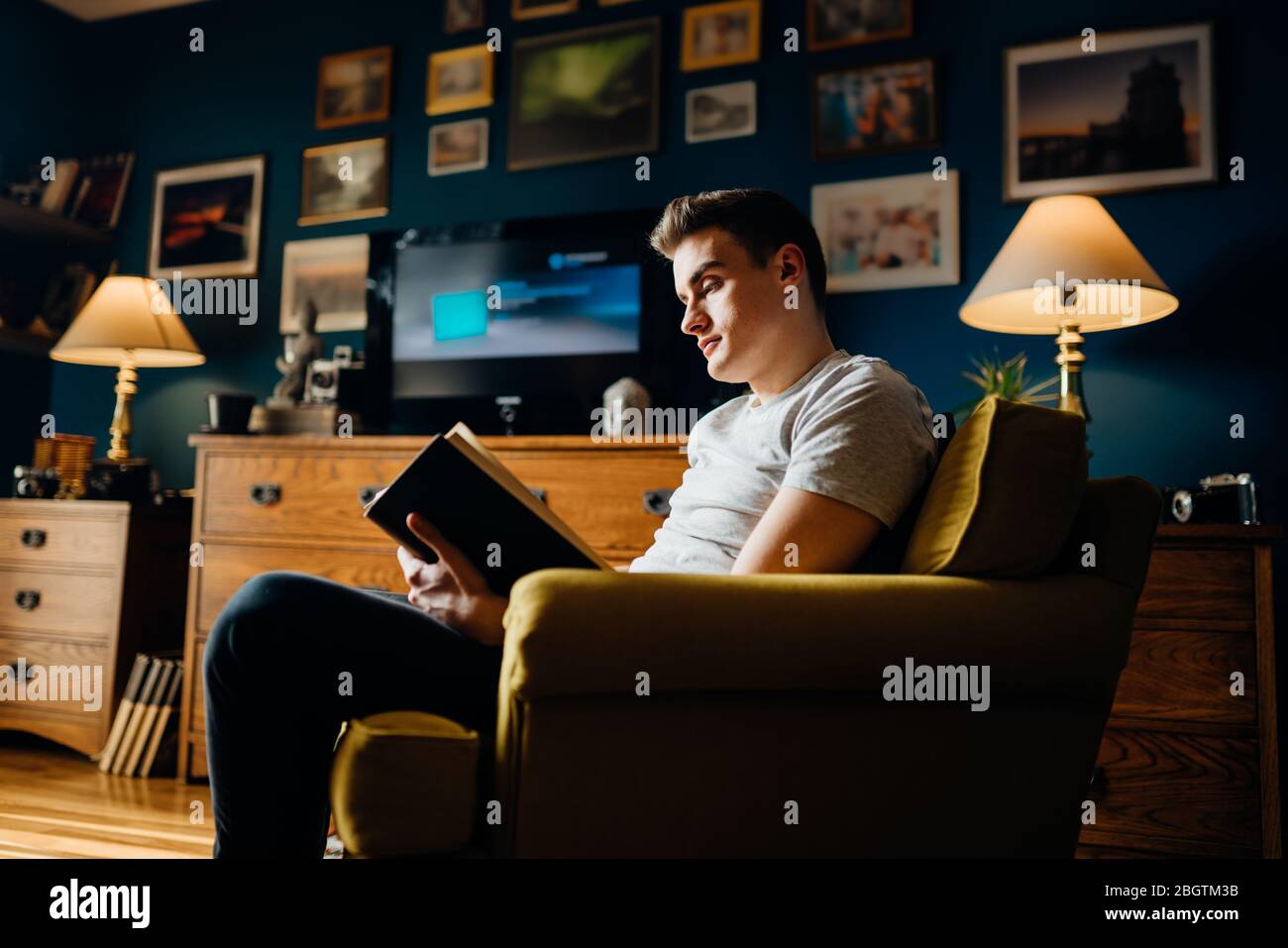 Man enjoying reading an interesting book,home alone in quarantine ...
