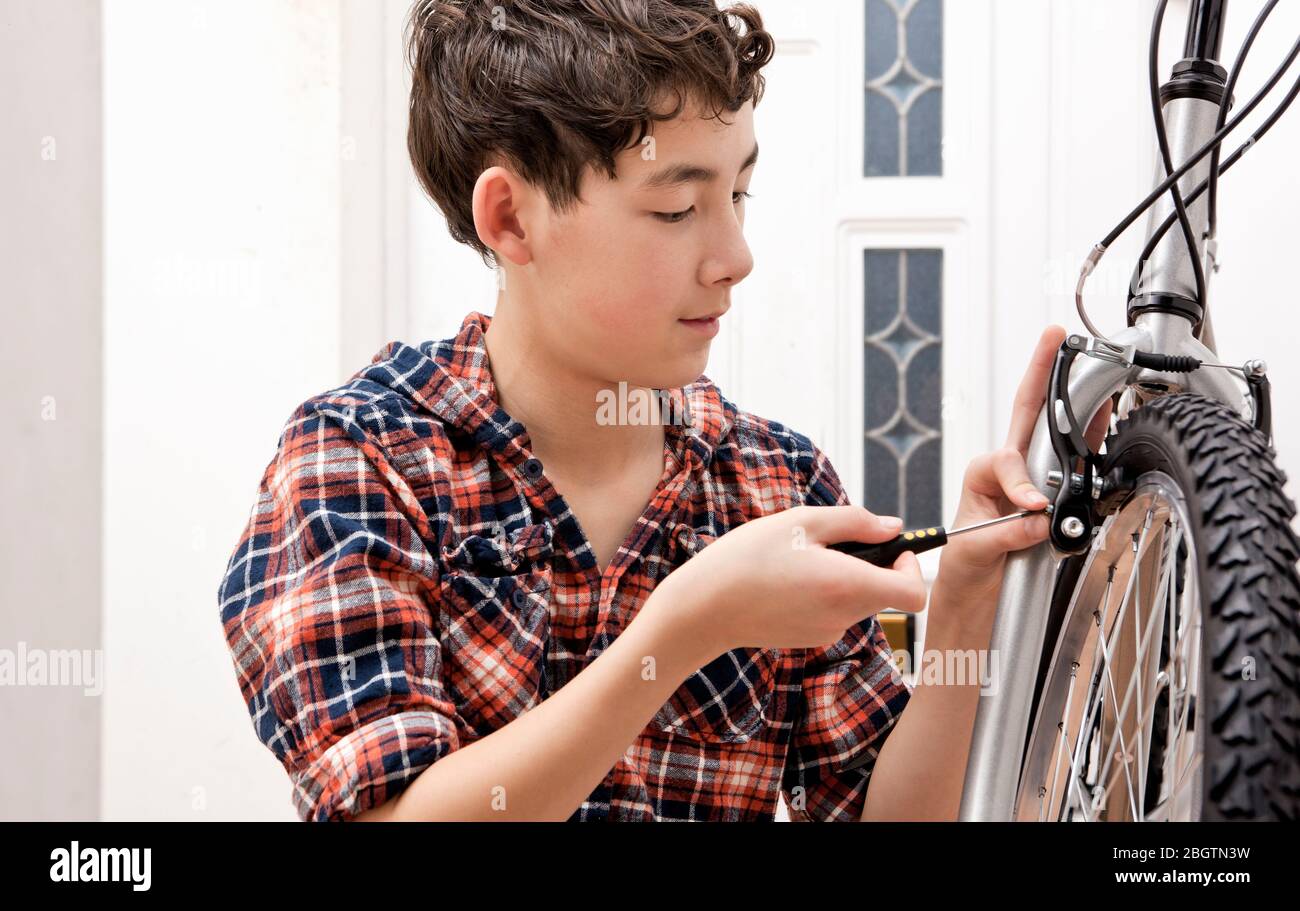 Boy is assembling his new mountain bike at home Stock Photo - Alamy