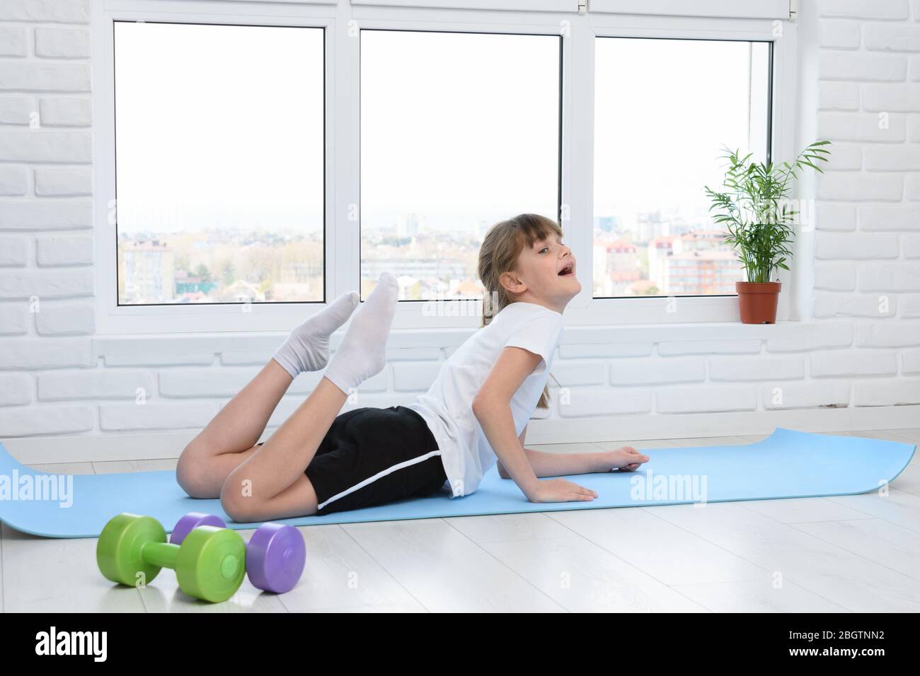 Girl can't do fish exercise to stretch her back Stock Photo - Alamy