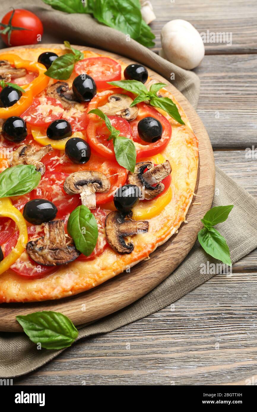 Delicious pizza served on wooden table Stock Photo - Alamy