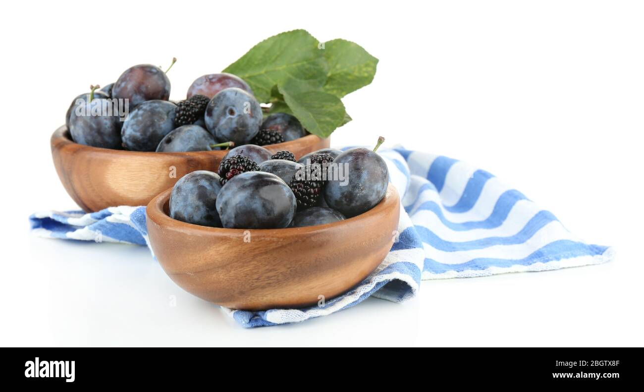 Ripe sweet plums in wooden bowls, isolated on white Stock Photo - Alamy