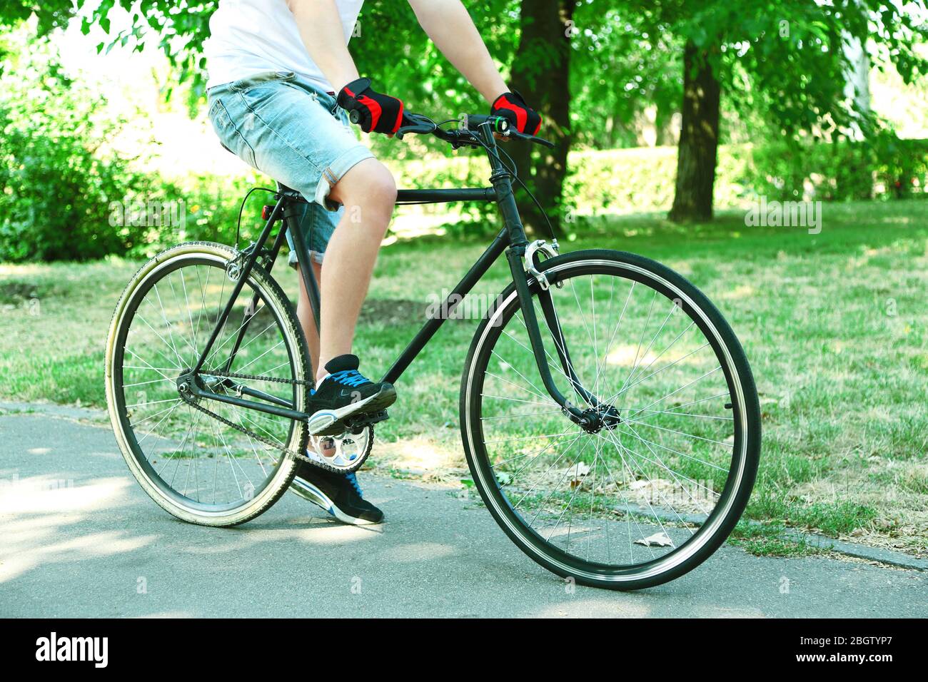 Man biking fast in city park. View from bikers eyes Stock Photo - Alamy