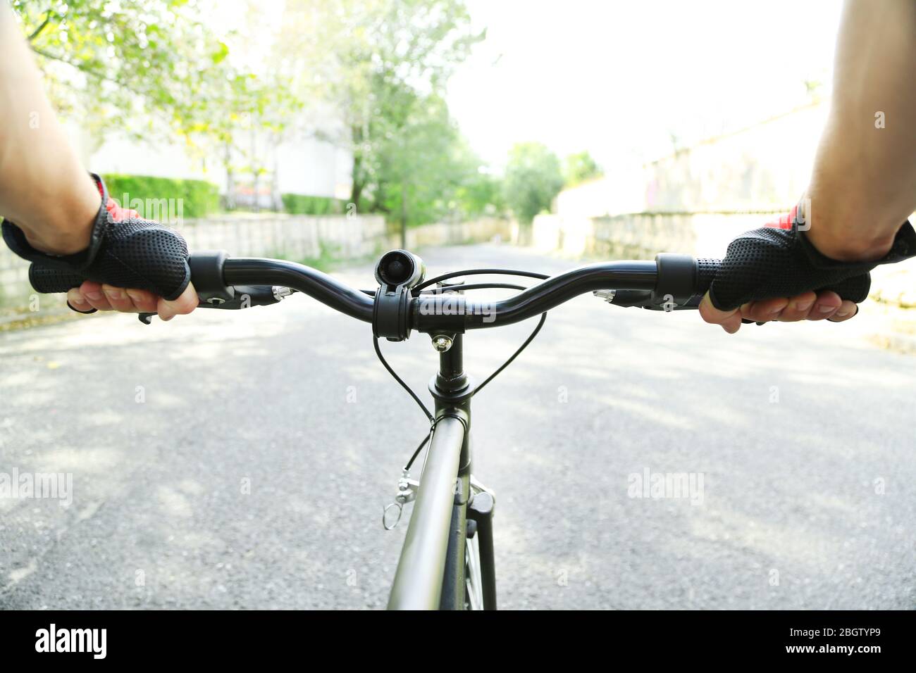 Man biking fast in city park. View from bikers eyes Stock Photo - Alamy