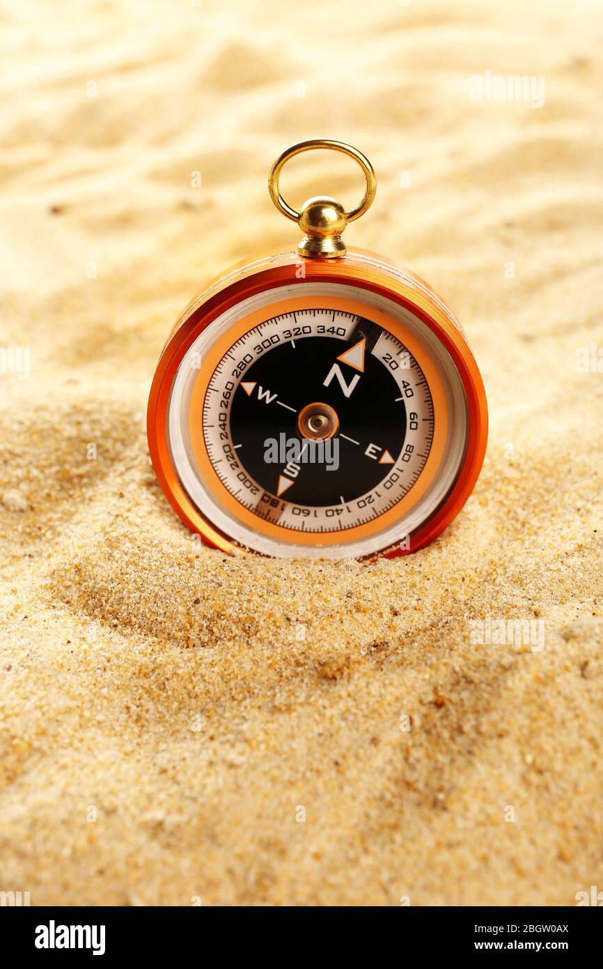 Compass on sand close-up Stock Photo - Alamy