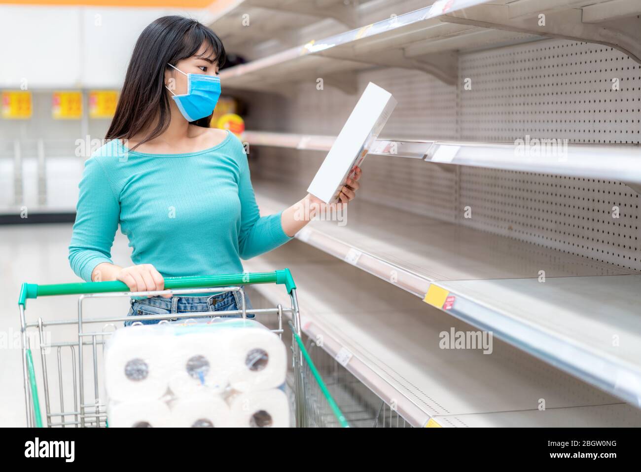 Asian woman looking at Supermarket empty cornflakes box shelves amid ...