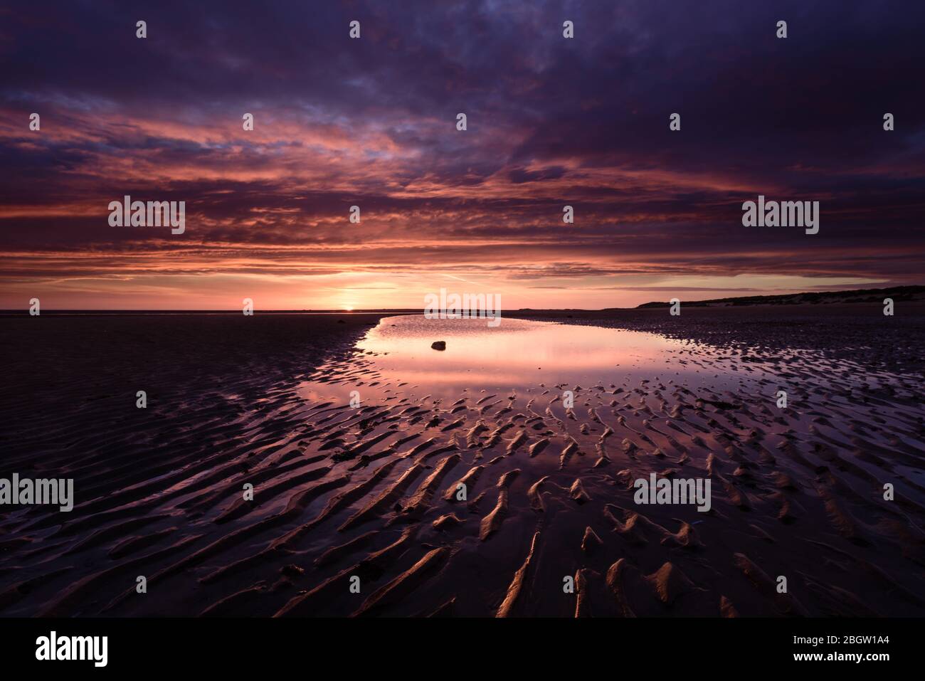 Low tide sunrise iii. Brancaster beach- Brancaster, July 2016 Stock ...