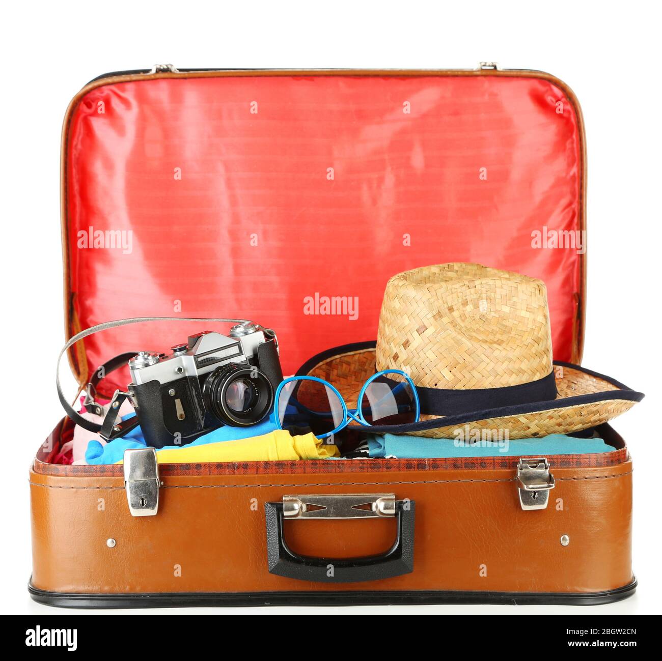 Female clothes and photo camera in old suitcase, isolated on white ...