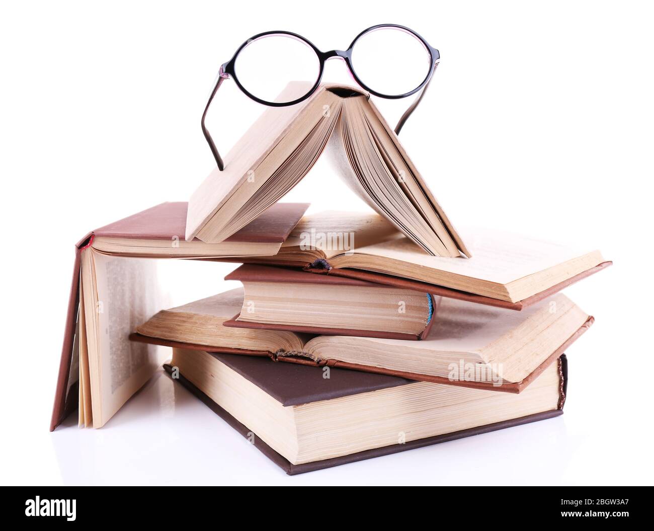 Books in a mess and glasses isolated on white Stock Photo - Alamy