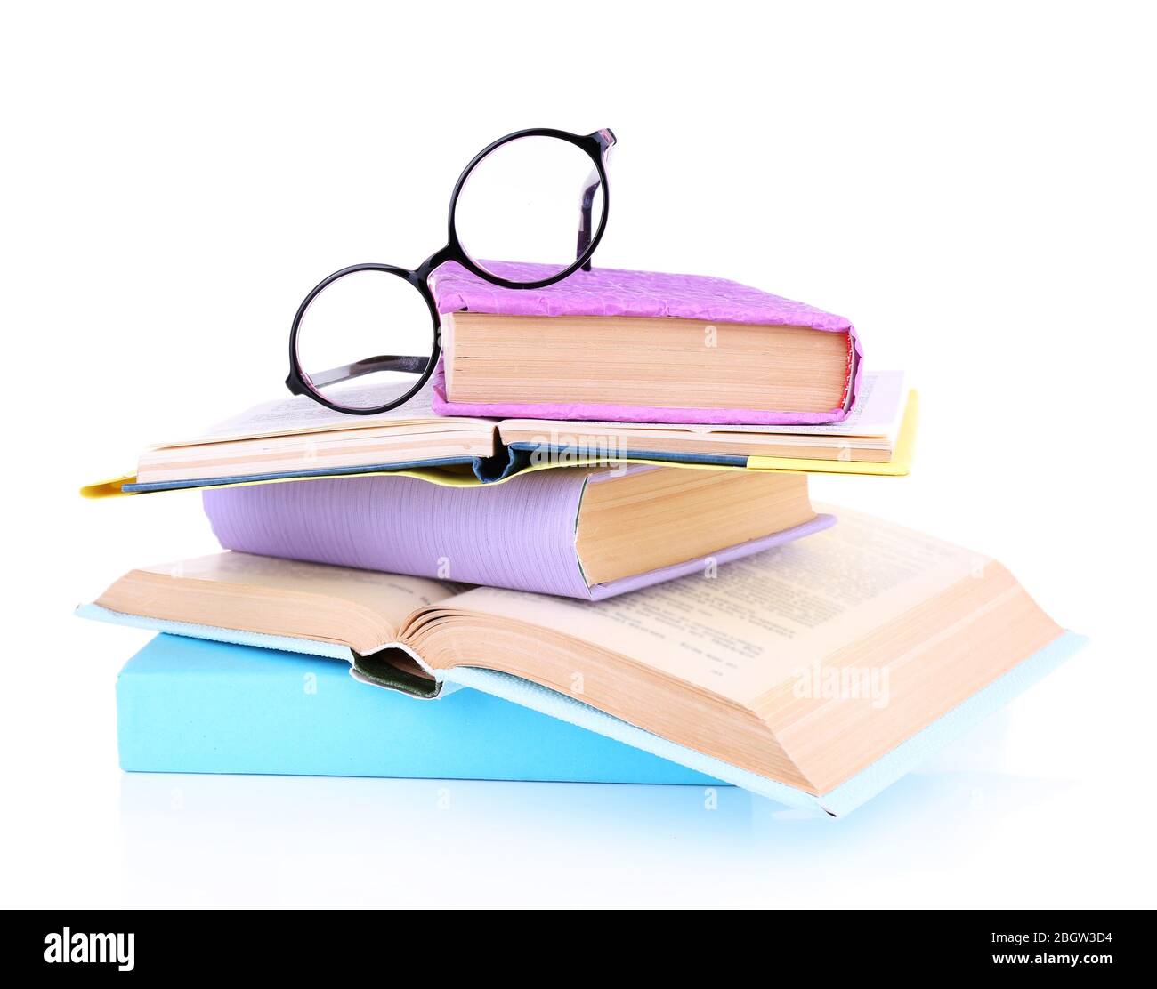 Books in a mess and glasses isolated on white Stock Photo - Alamy