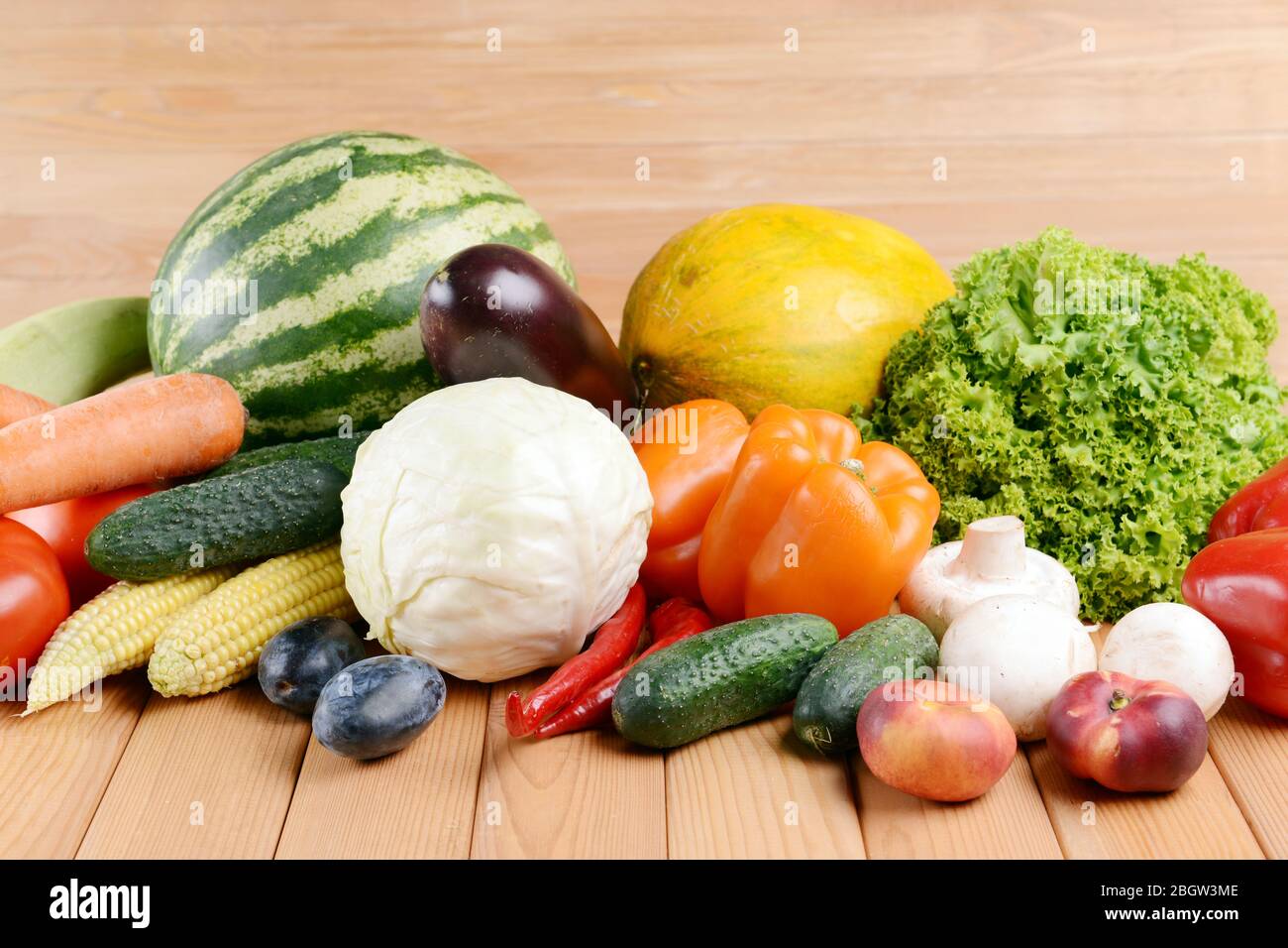 Fresh organic fruits and vegetables on wooden background Stock Photo ...