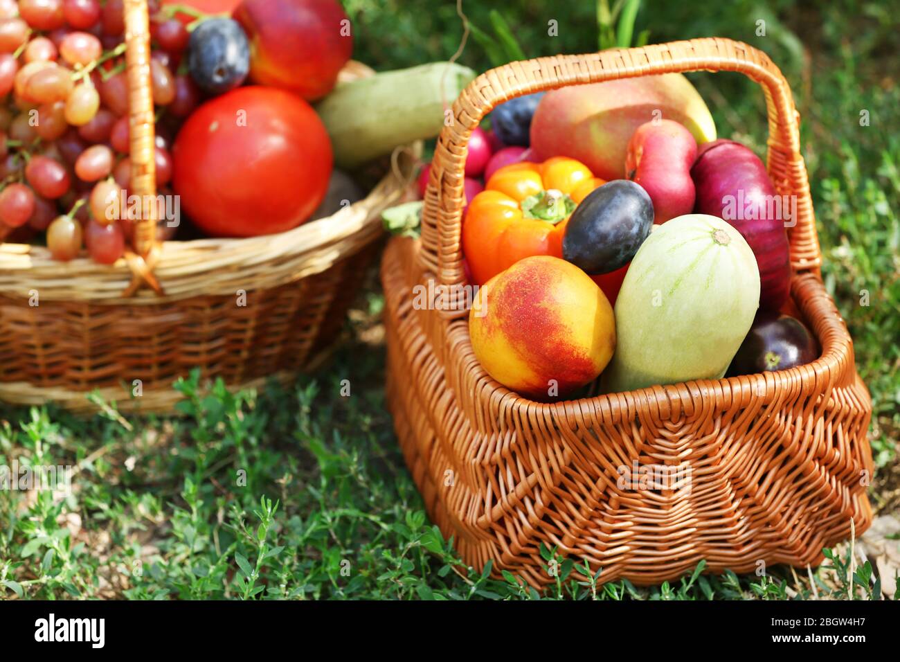 Fresh organic fruits and vegetables in wicker baskets outdoors Stock ...