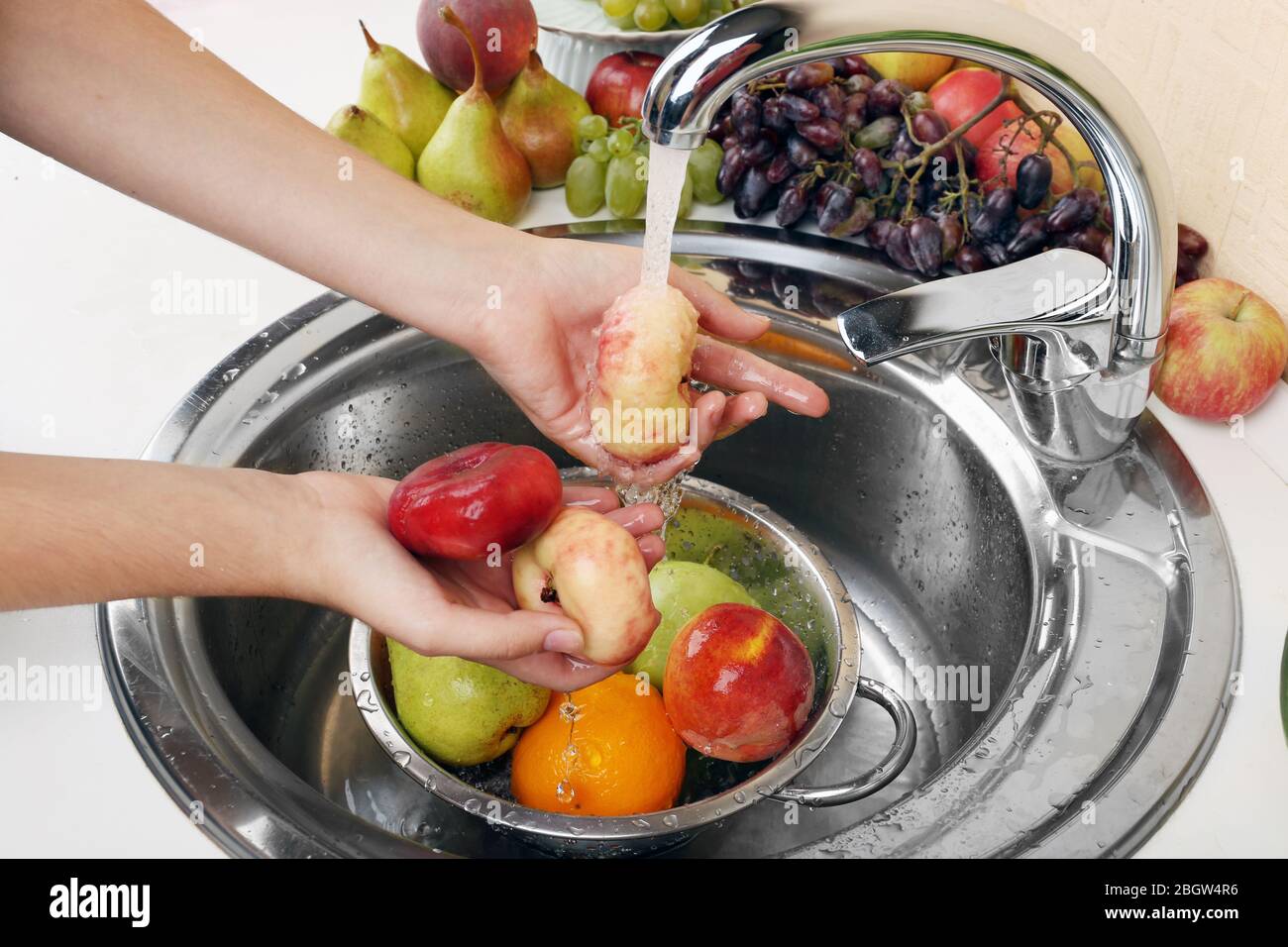 Washing fruits in sink hi-res stock photography and images - Alamy