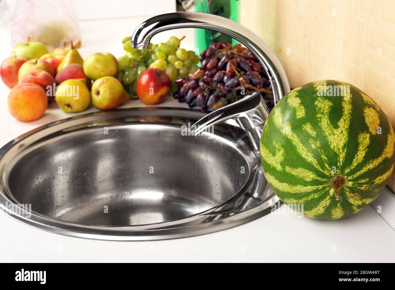 Fruits on table beside sink Stock Photo - Alamy