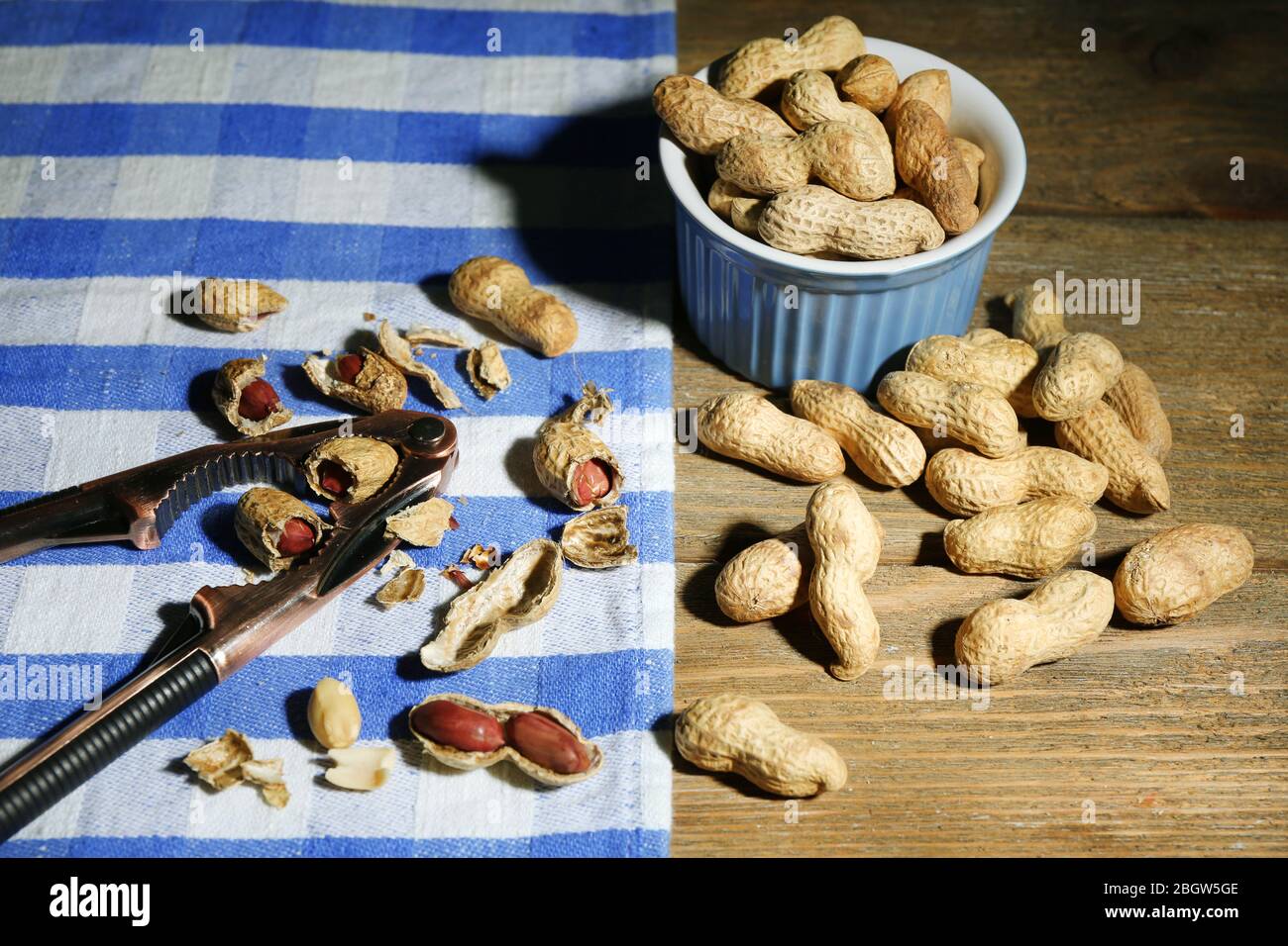 Peanuts on blue napkin, on wooden background Stock Photo - Alamy