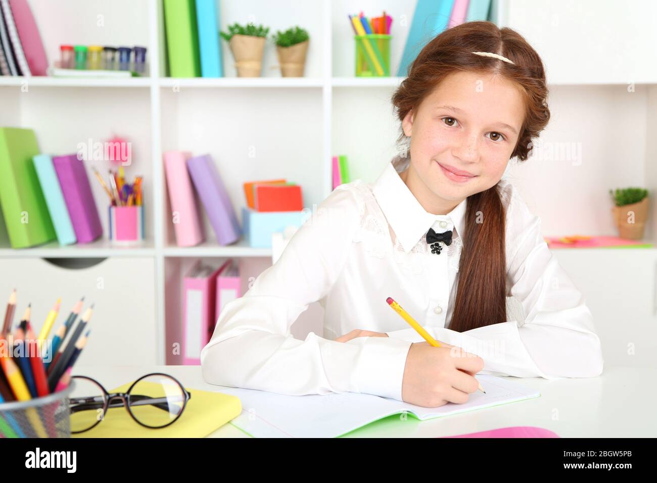 Cute girl at workplace in classroom Stock Photo - Alamy