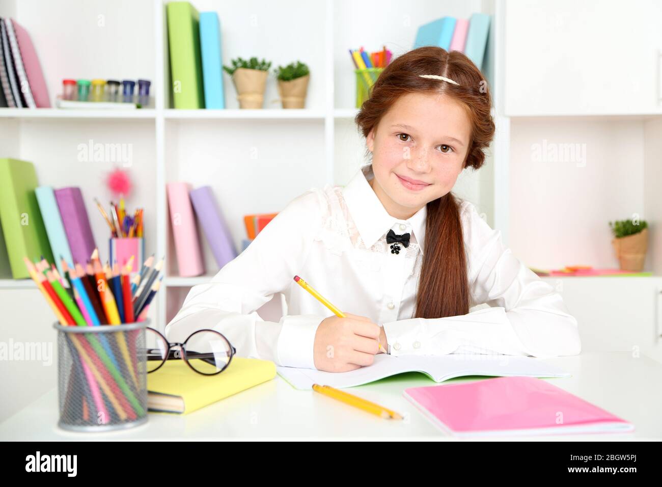 Cute girl at workplace in classroom Stock Photo - Alamy