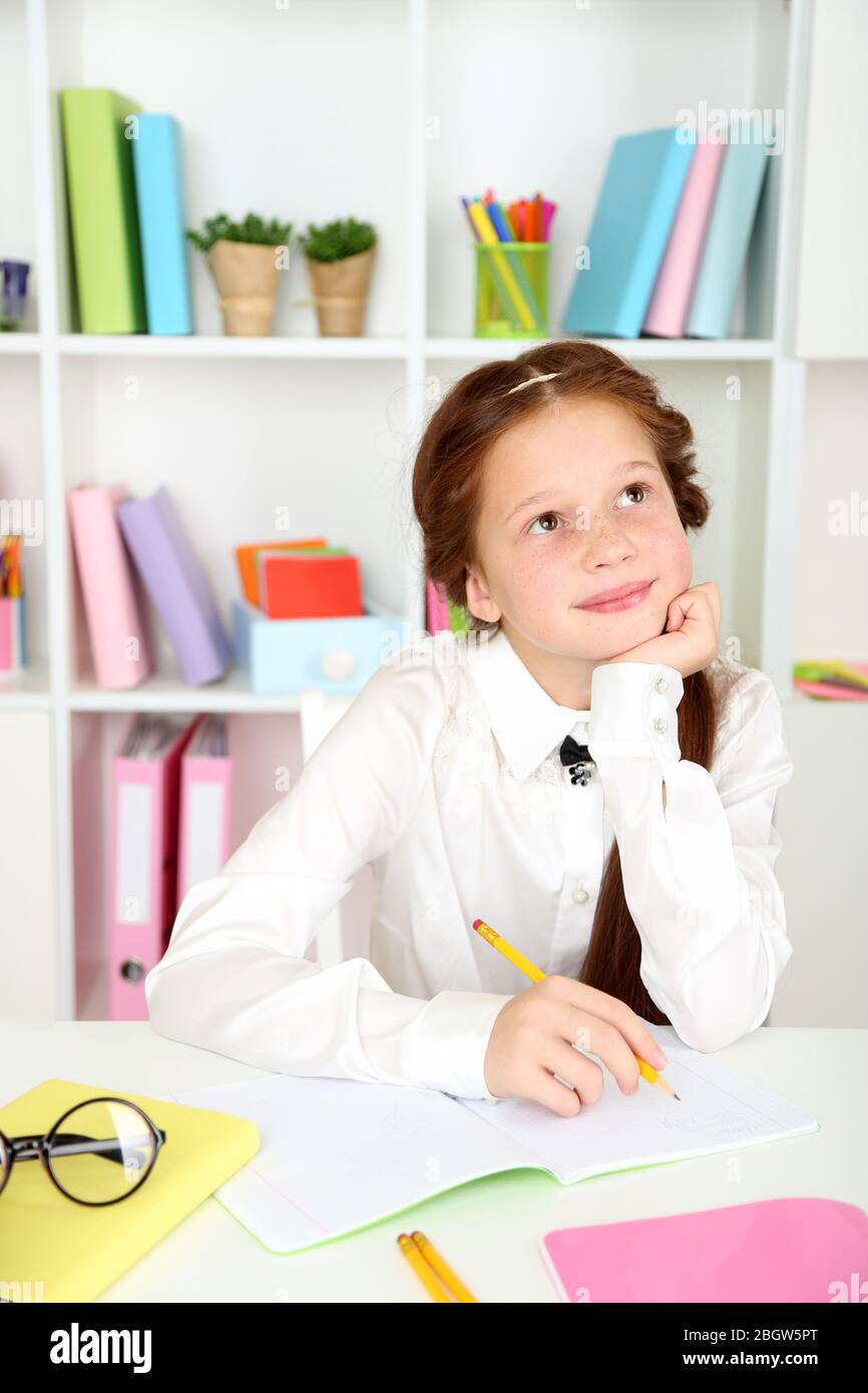 Cute girl at workplace in classroom Stock Photo - Alamy