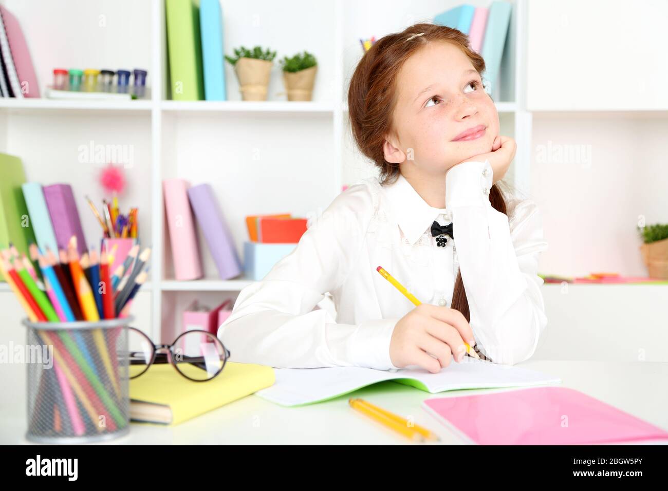Cute girl at workplace in classroom Stock Photo - Alamy
