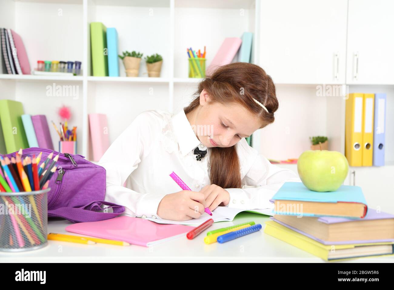 Cute girl at workplace in classroom Stock Photo - Alamy
