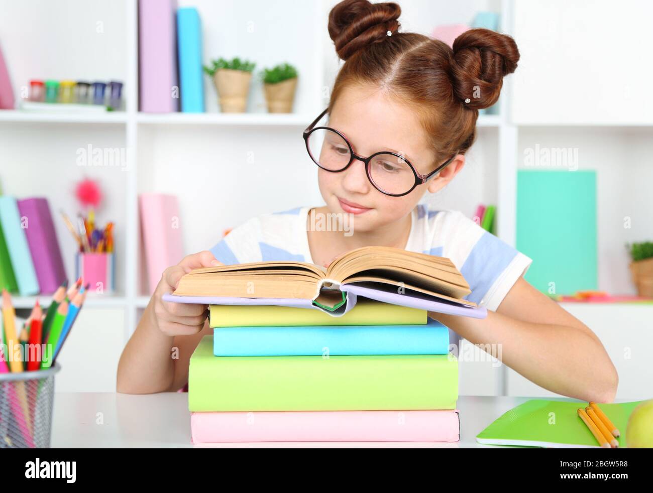 Cute girl at workplace in classroom Stock Photo - Alamy