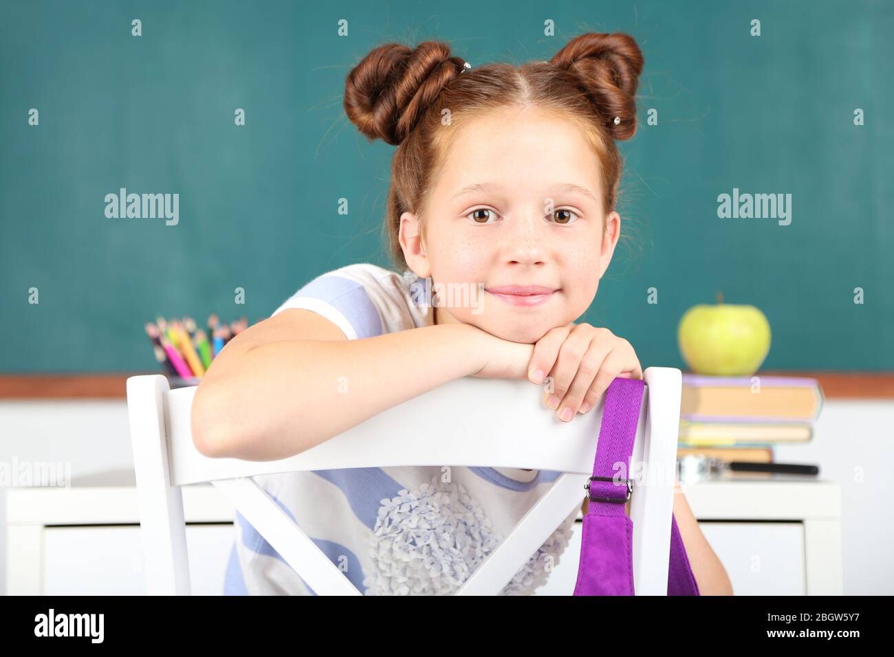 Cute girl at workplace in classroom Stock Photo - Alamy