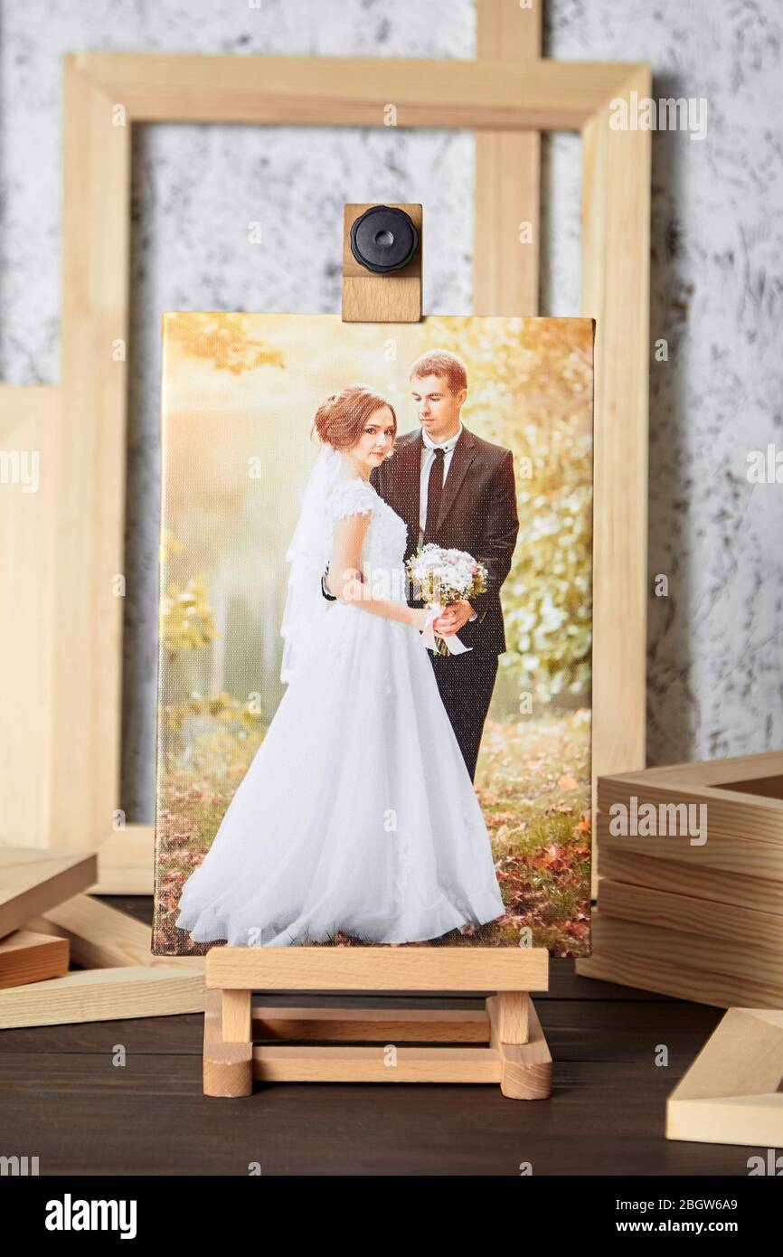 Wedding photo printed on canvas, a wooden easel and stretcher bars on ...