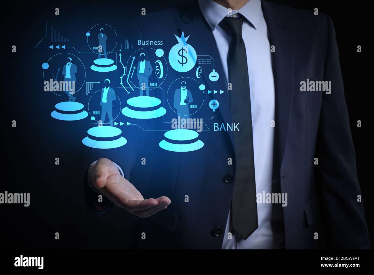 Male bank manager using virtual screen on dark background Stock Photo ...