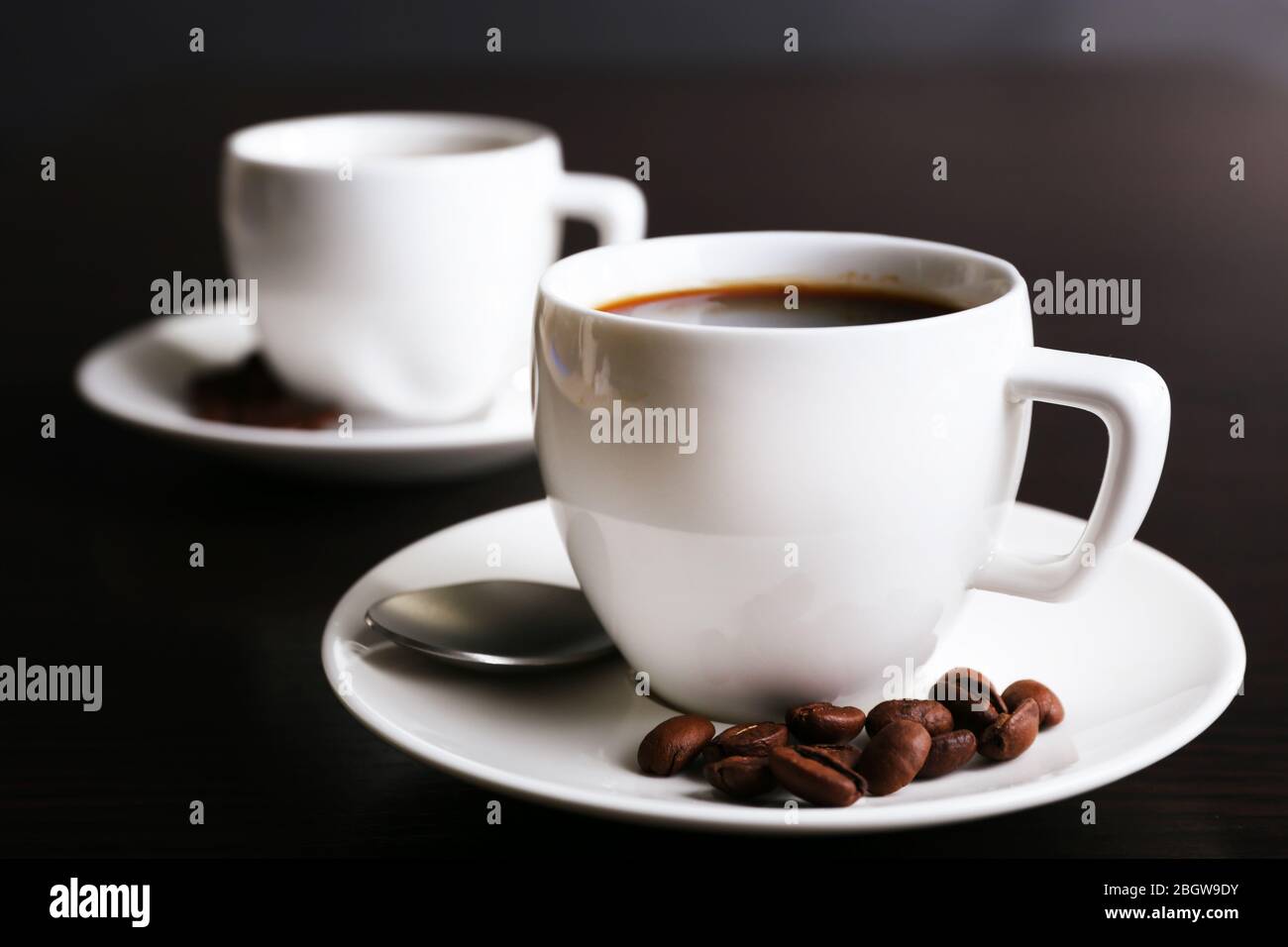 Two cups of black coffee with beans on saucer hi-res stock photography ...