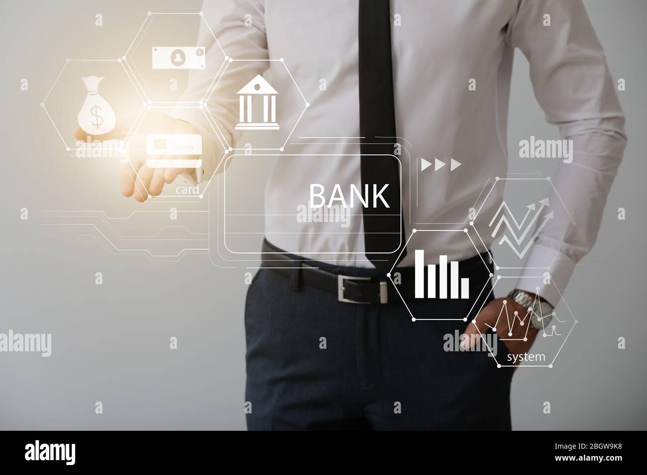 Male bank manager using virtual screen on grey background Stock Photo ...