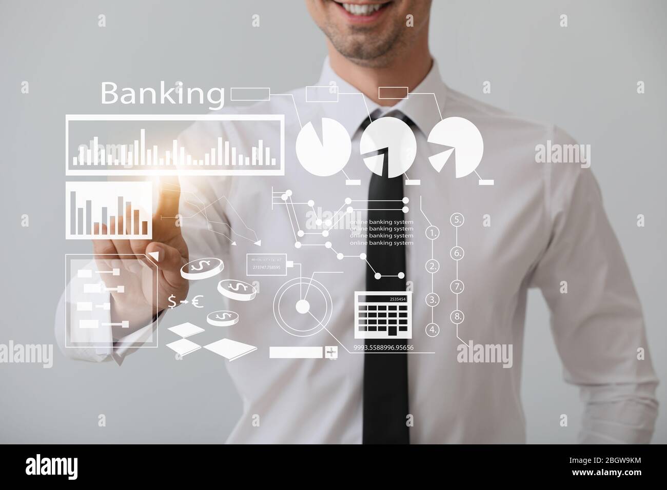 Male bank manager using virtual screen on grey background Stock Photo ...