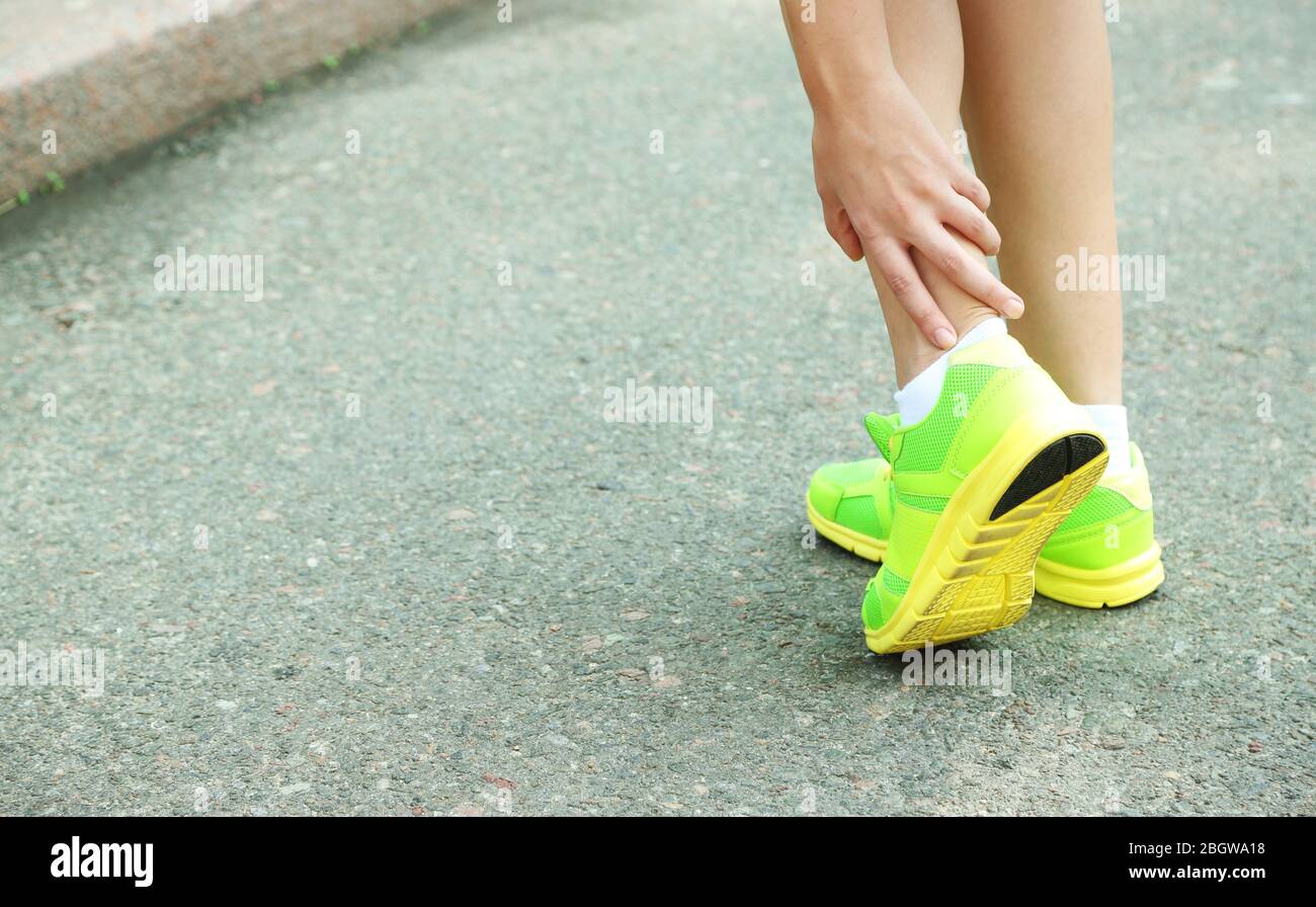 Sports injuries of girl outdoors Stock Photo - Alamy