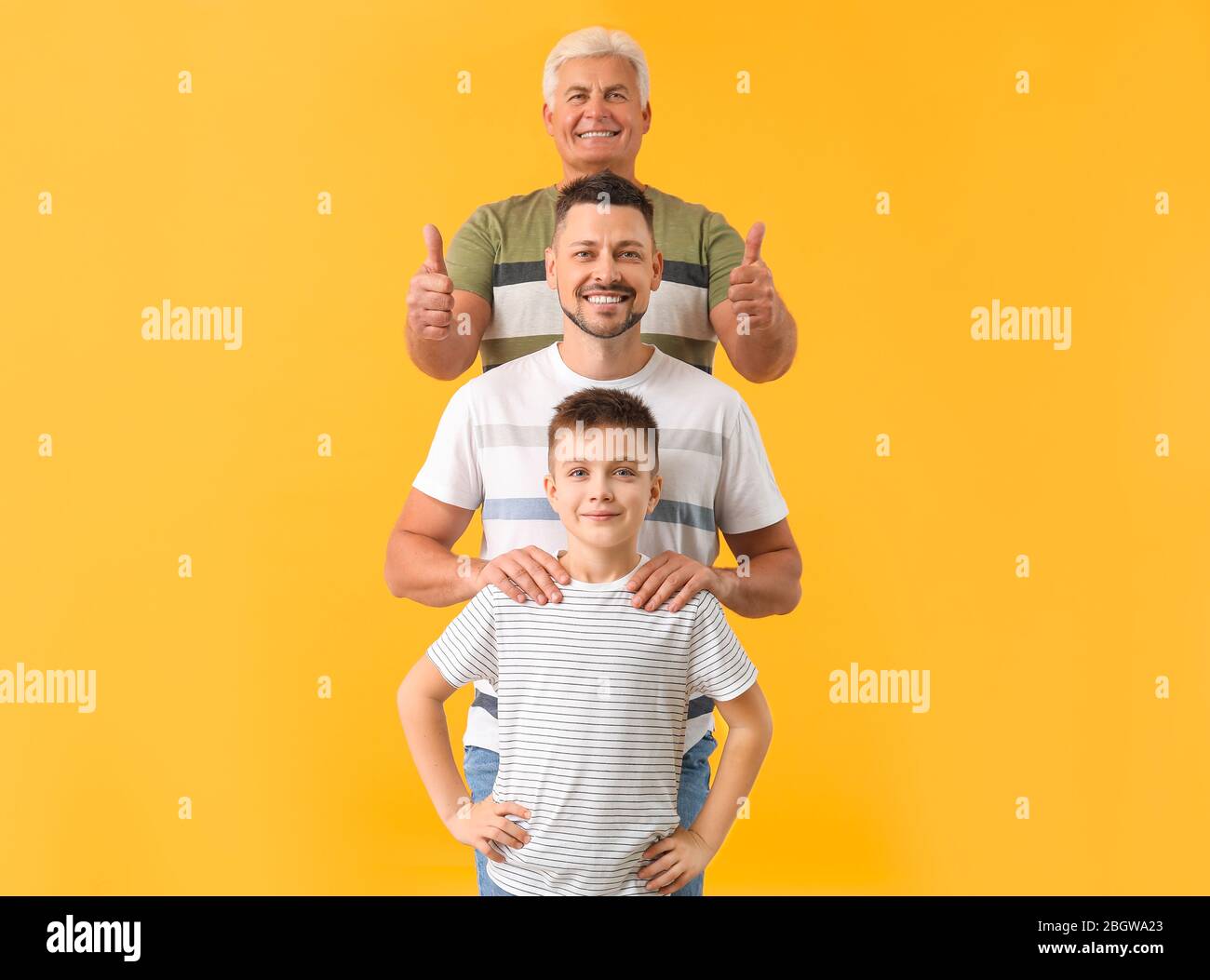 Man with his father and son on color background Stock Photo - Alamy