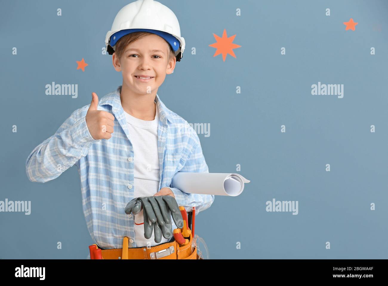 Cute little electrician showing thumb-up on color background Stock ...