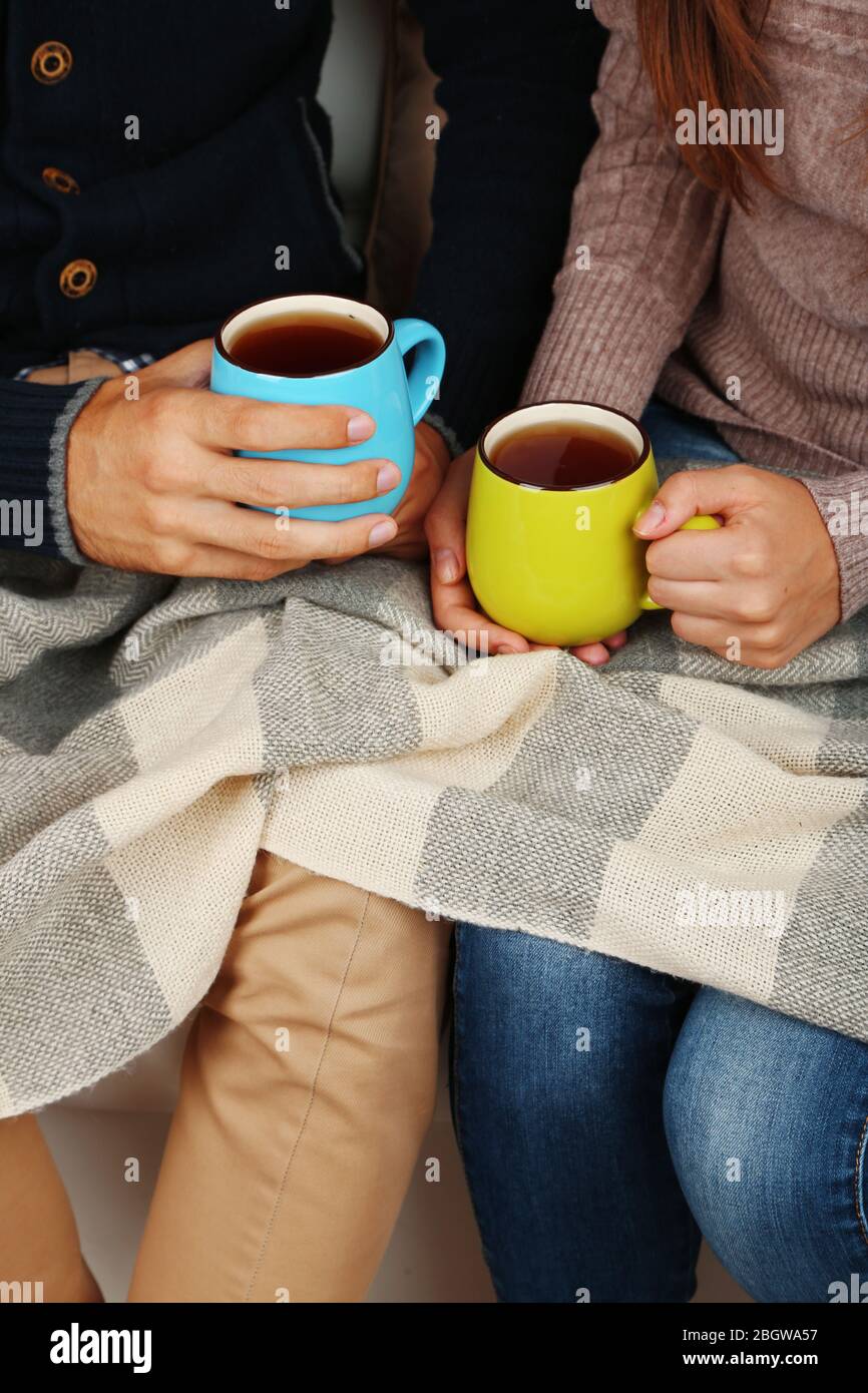 Loving couple with hot drinks Stock Photo - Alamy
