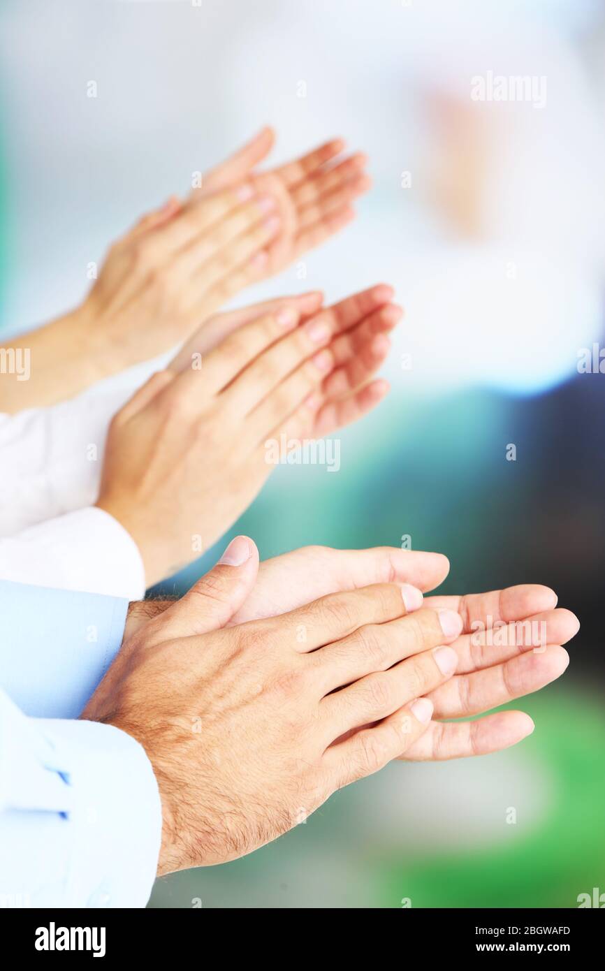 Clapping hands on bright background Stock Photo - Alamy