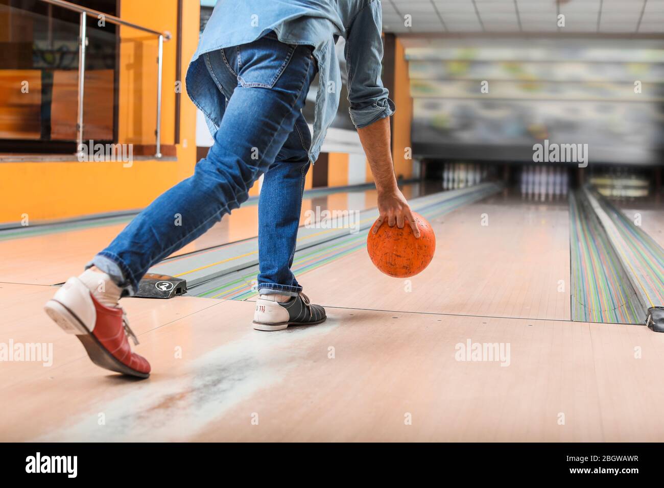 Man playing bowling in club Stock Photo - Alamy