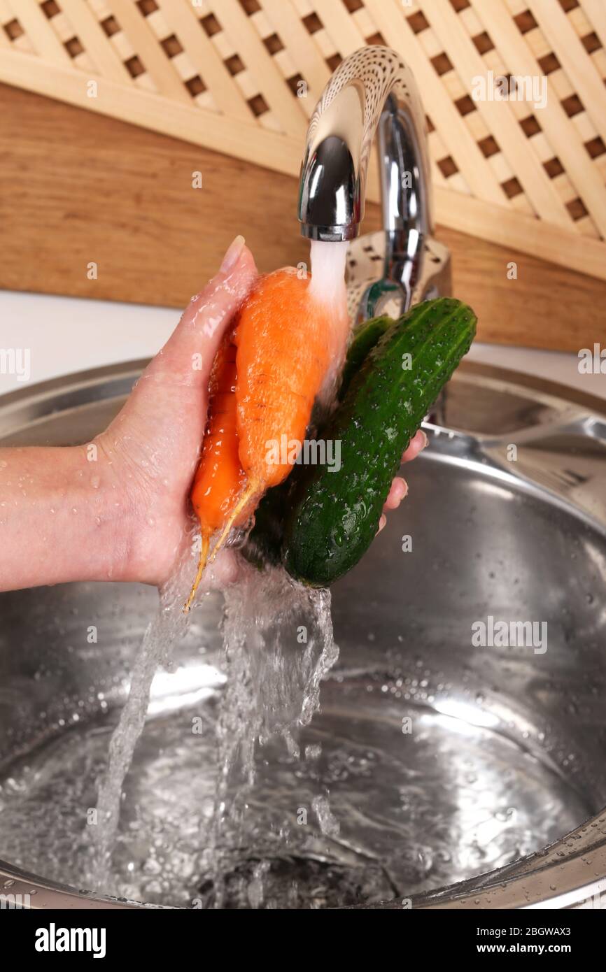 Hands washing vegetables close up hi-res stock photography and images ...