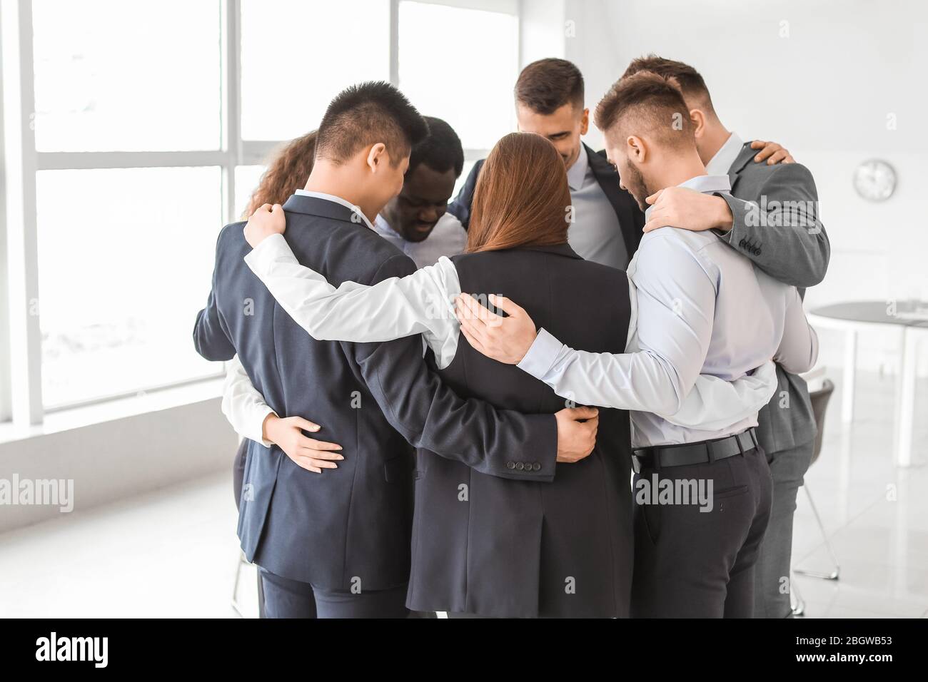 Business people hugging in circle hi-res stock photography and images ...