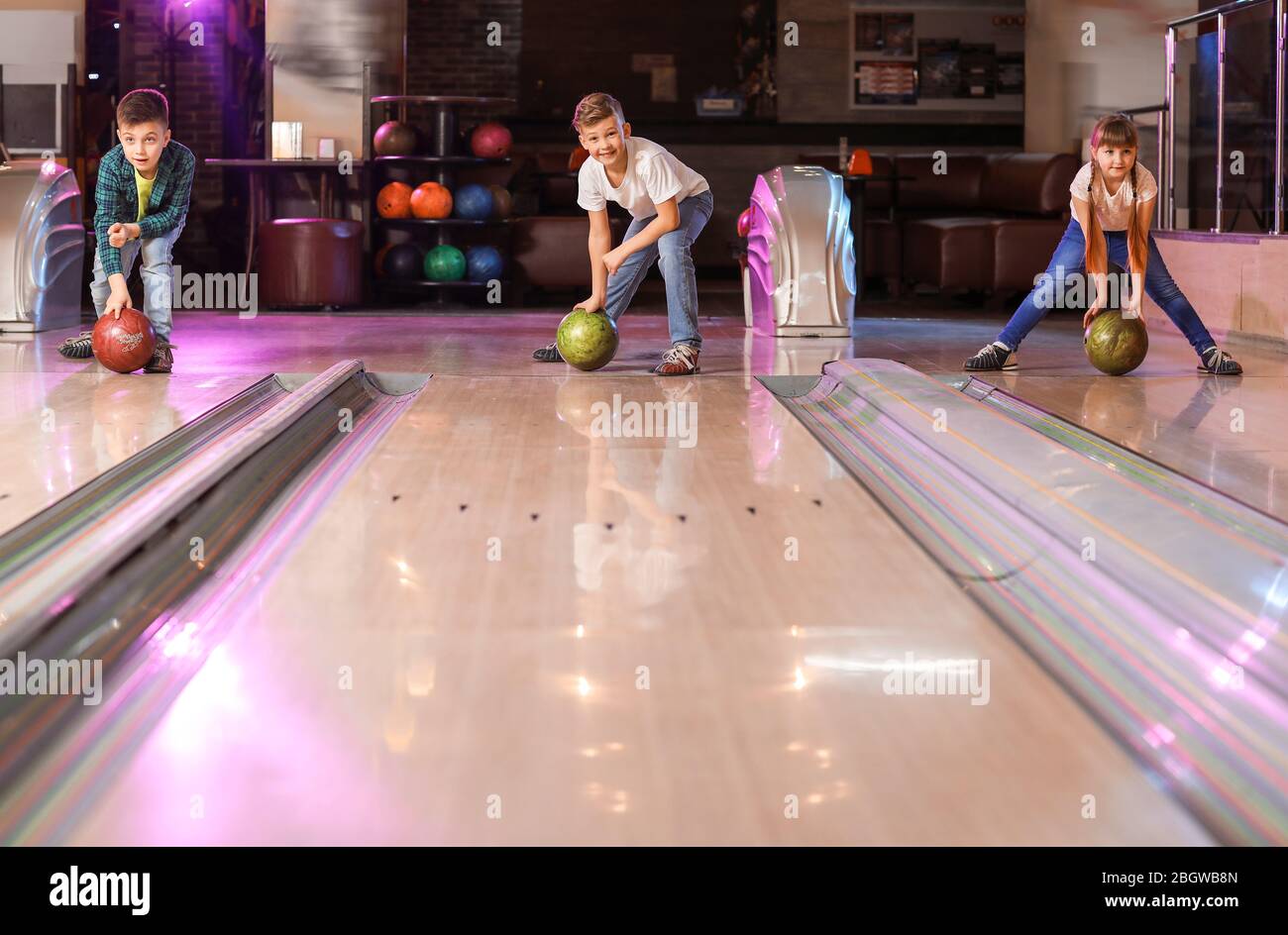Little children playing bowling in club Stock Photo - Alamy