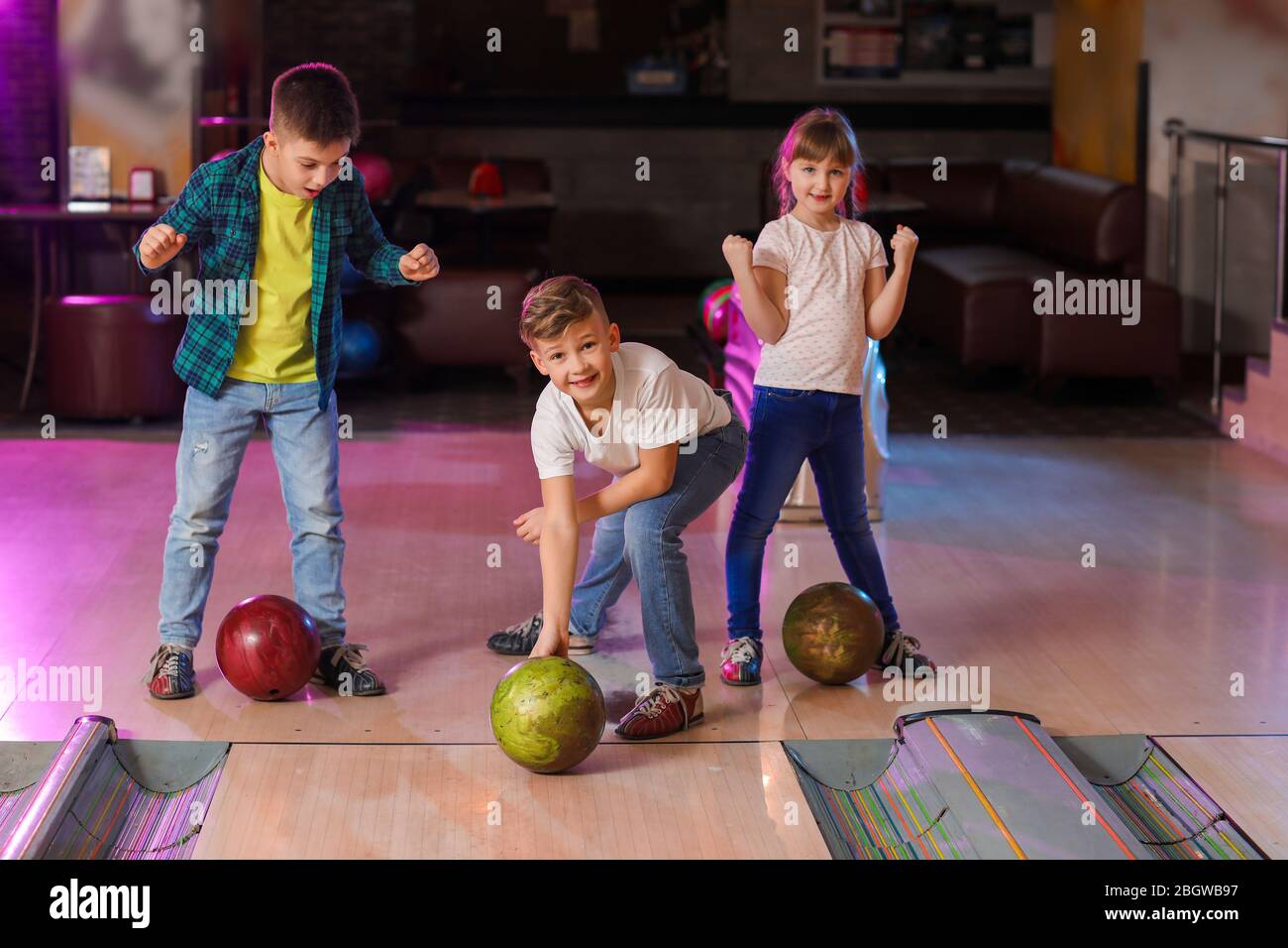 Little children playing bowling in club Stock Photo - Alamy