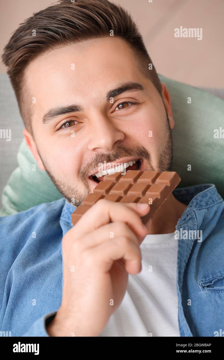 Guy eating chocolate bar and happy hi-res stock photography and images ...