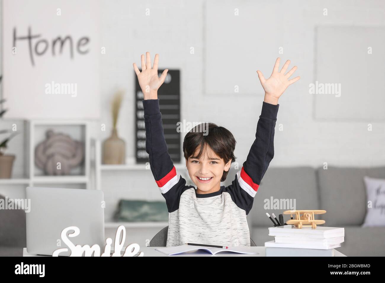 Happy little boy doing homework in room Stock Photo - Alamy