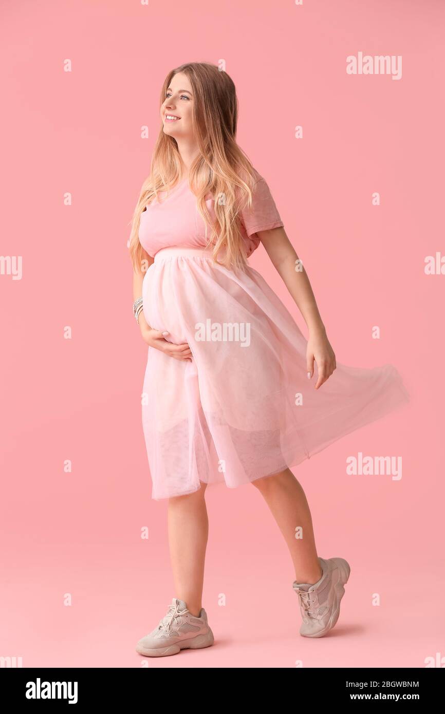 Beautiful young pregnant woman on color background Stock Photo - Alamy