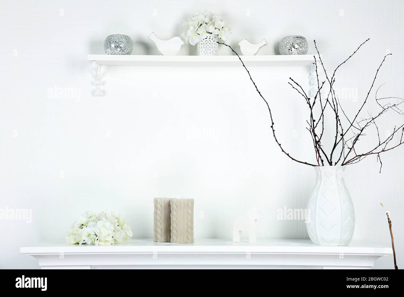 Different objects on white shelf in living room Stock Photo - Alamy
