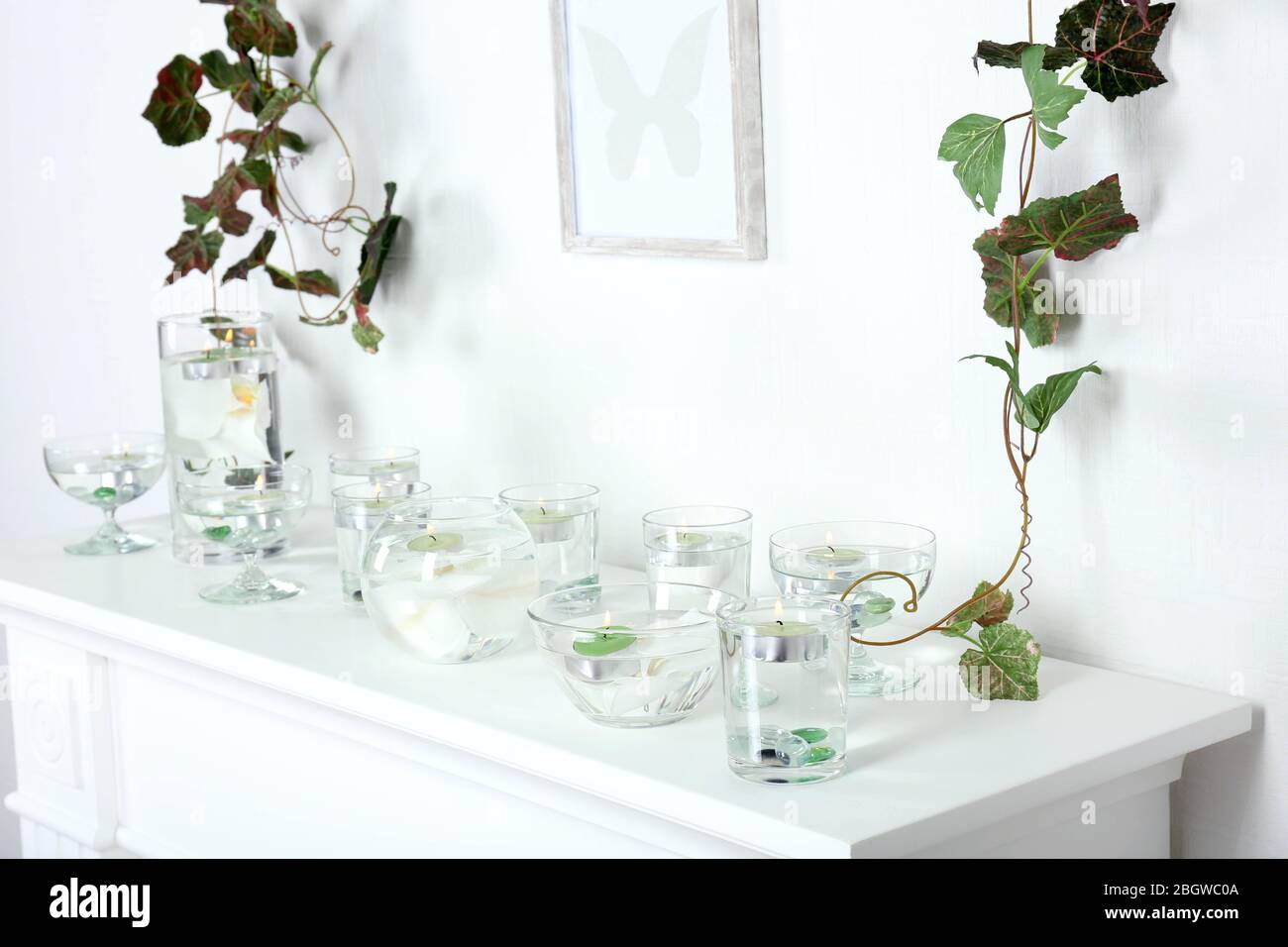 Different objects on white shelf in living room Stock Photo - Alamy
